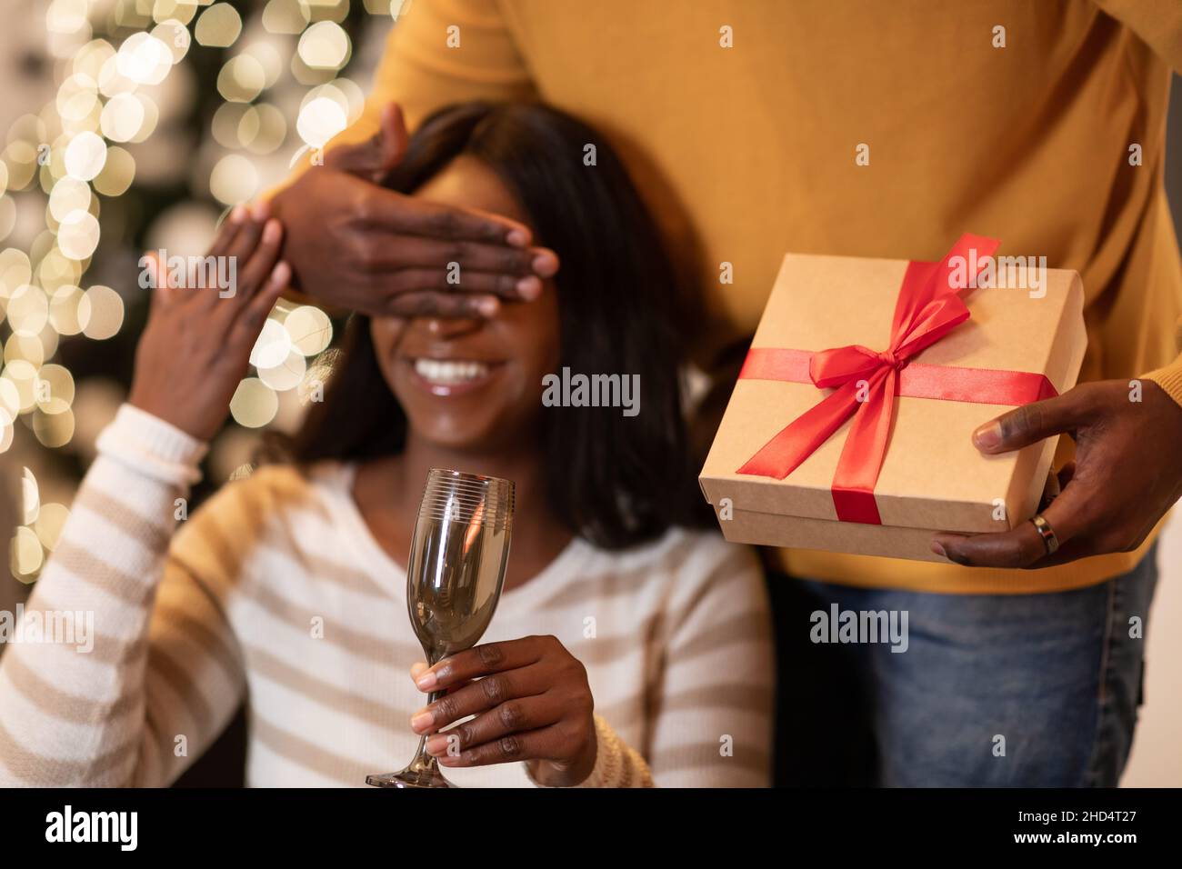 African Man Giving Woman Gift Covering Eyes Celebrating Christmas ...