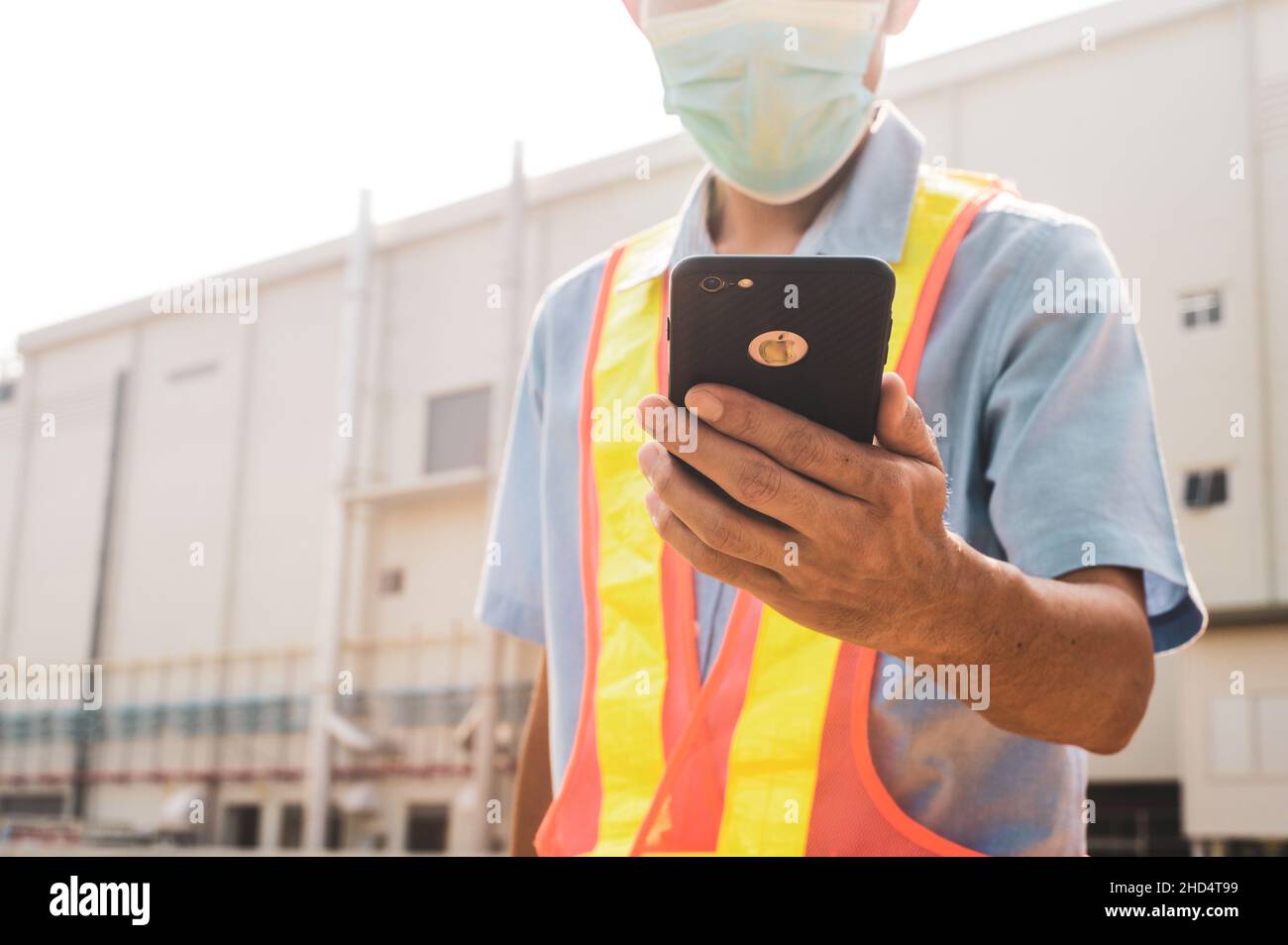 Engineer using smart phone communication company industrial background ...