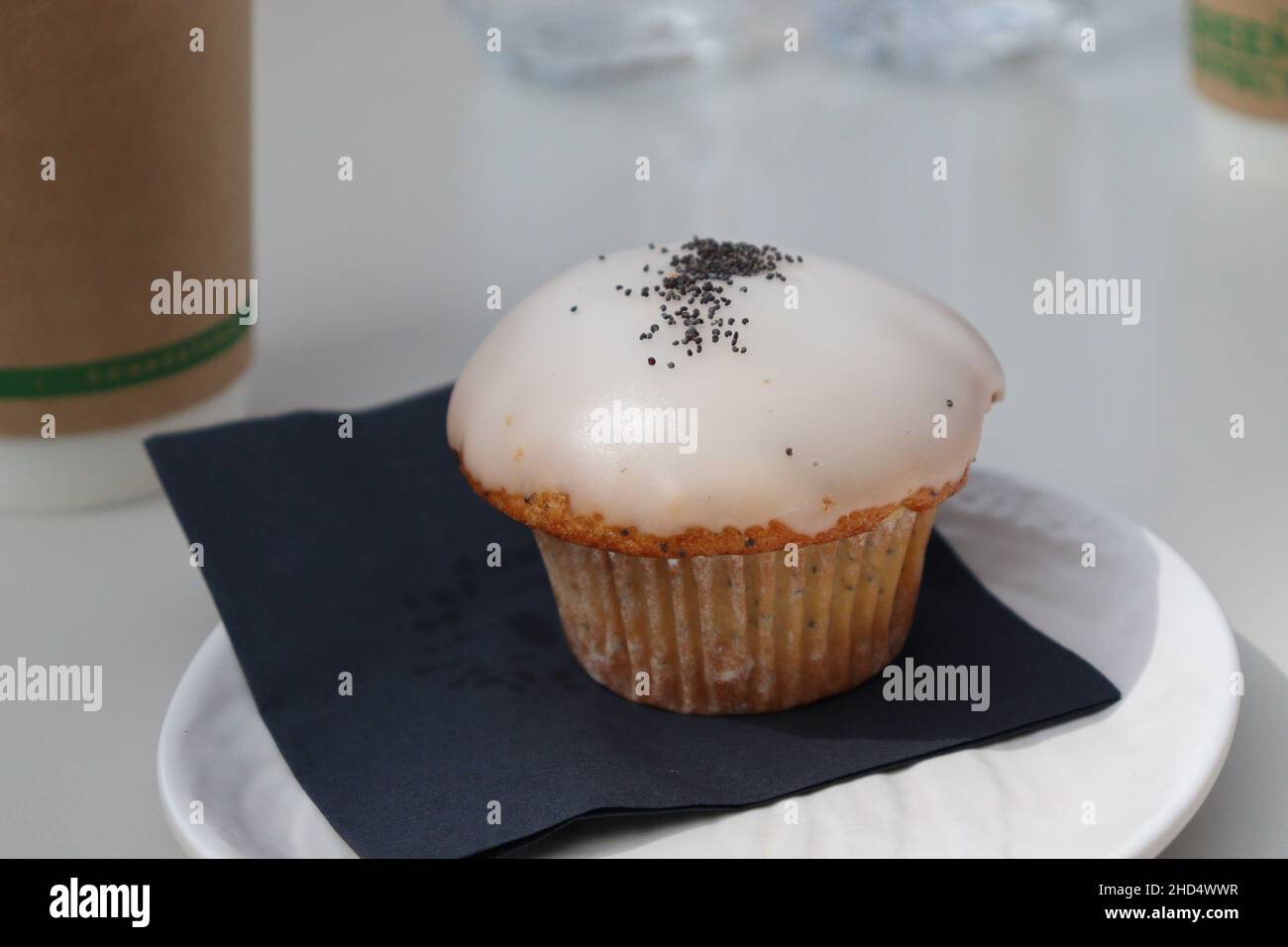 An iced lemon and poppy seed muffin Stock Photo - Alamy
