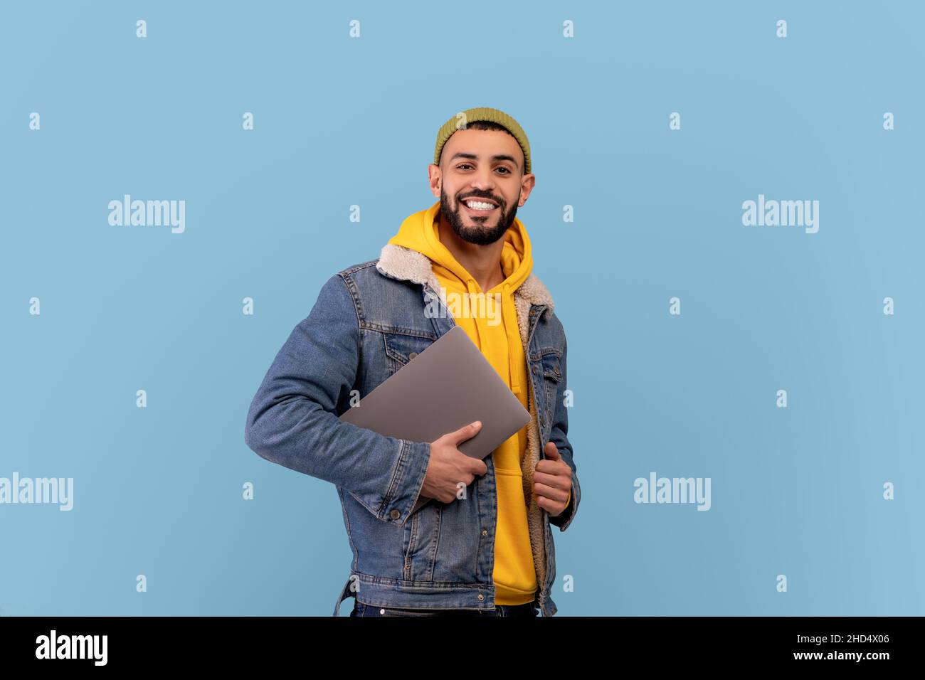 Happy middle eastern guy holding laptop and smiling at camera, arabic ...