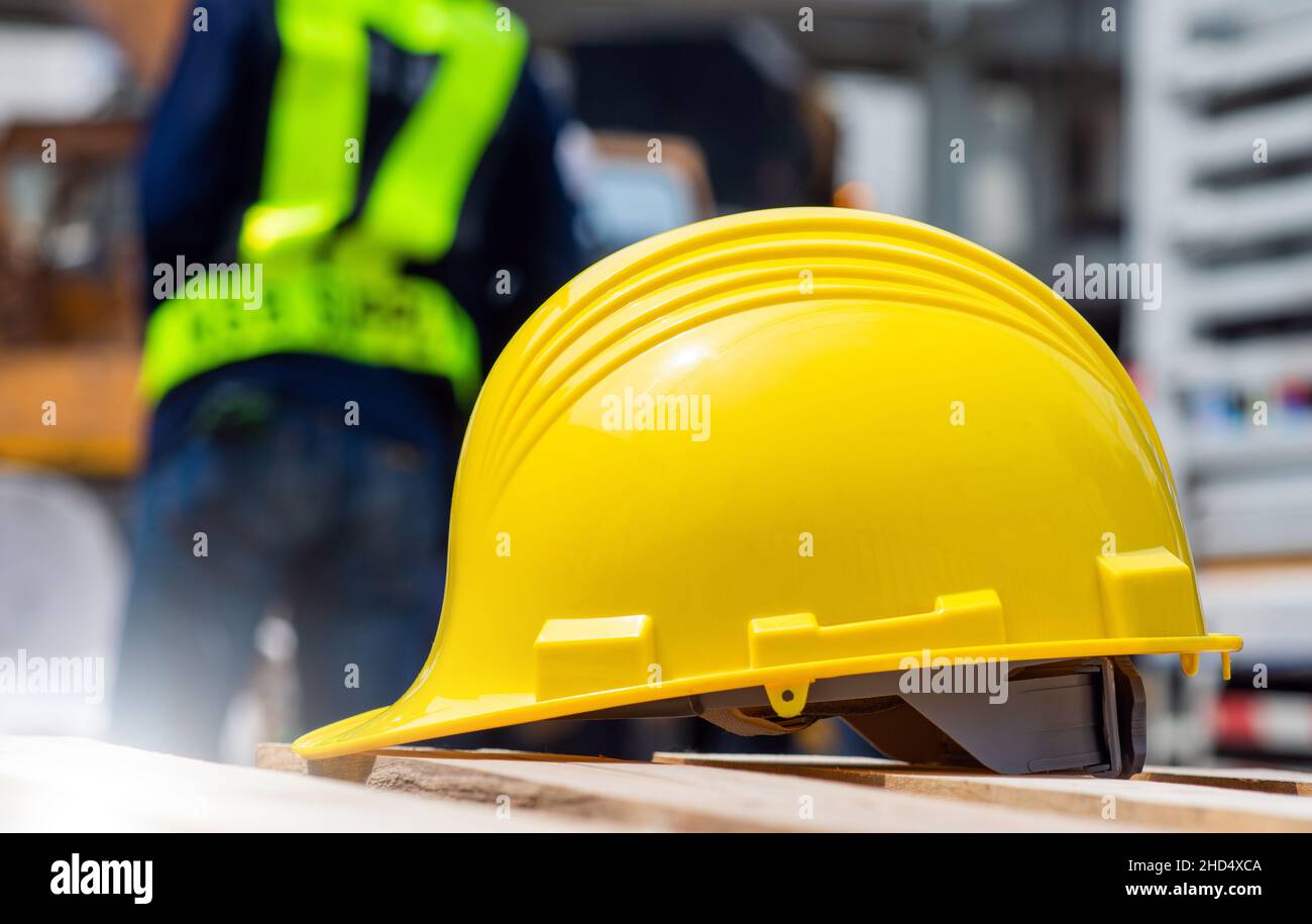 Yellow helmet on site construction background, Safety hardhat , Hard ...