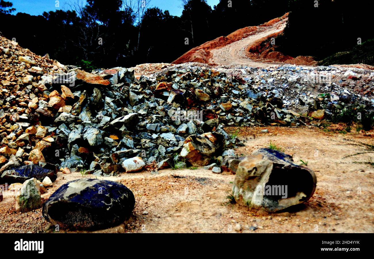 Chunks of rock the effect of human greed Stock Photo - Alamy