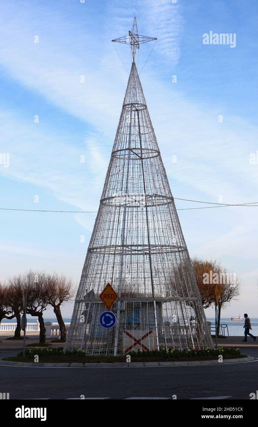 Artificial tall Christmas tree at a roundabout in morning sun Sardinero ...