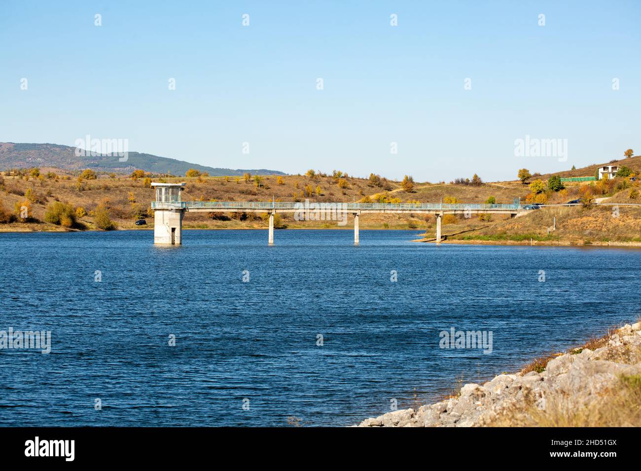 Shot of a bridge with watching point room over a river and mountain ...