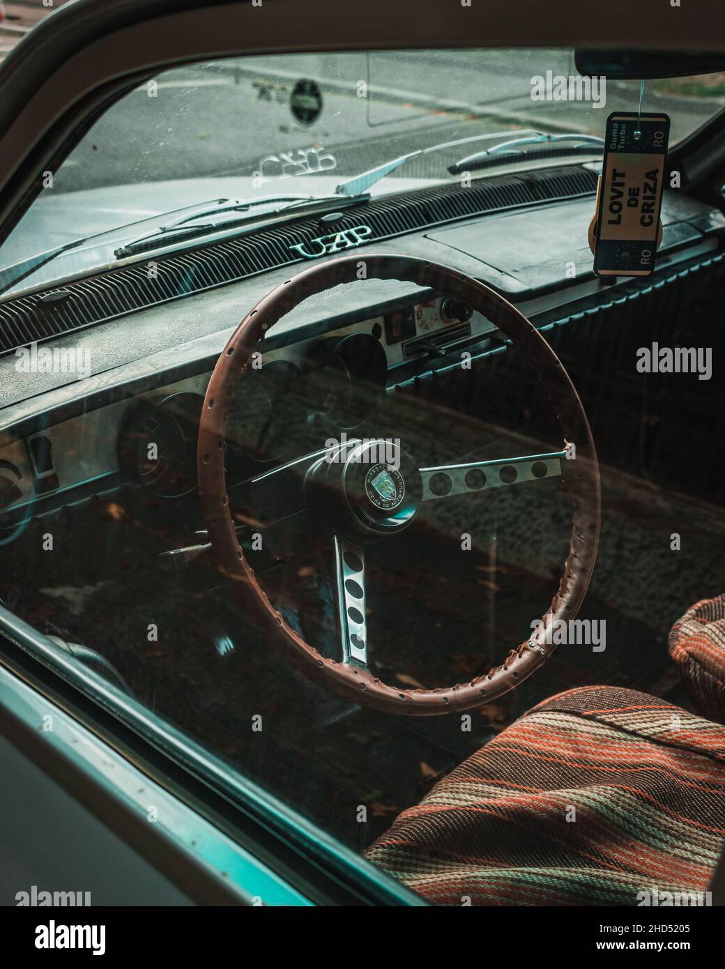 Steering wheel and dashboard of an old Dacia 1300 captured through the ...