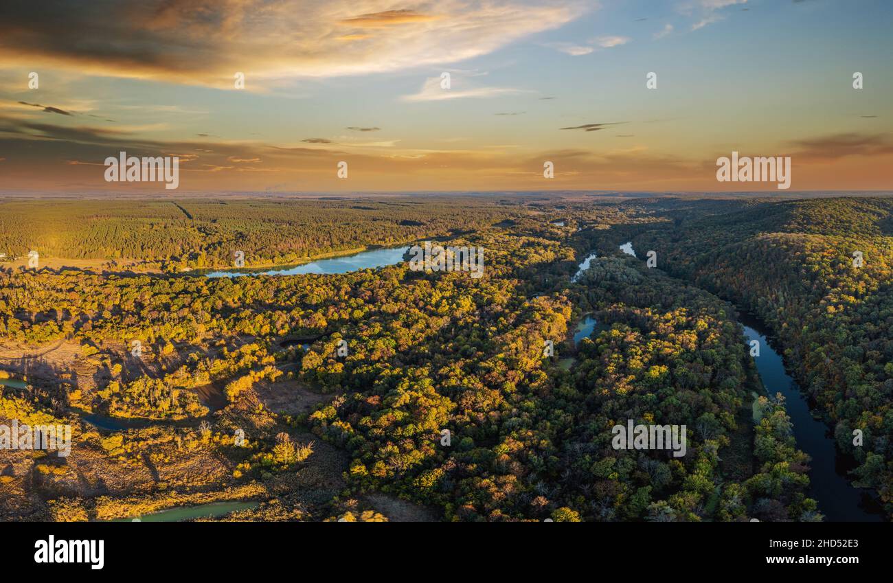 Country ground road stretching between green meadows and long narrow ...