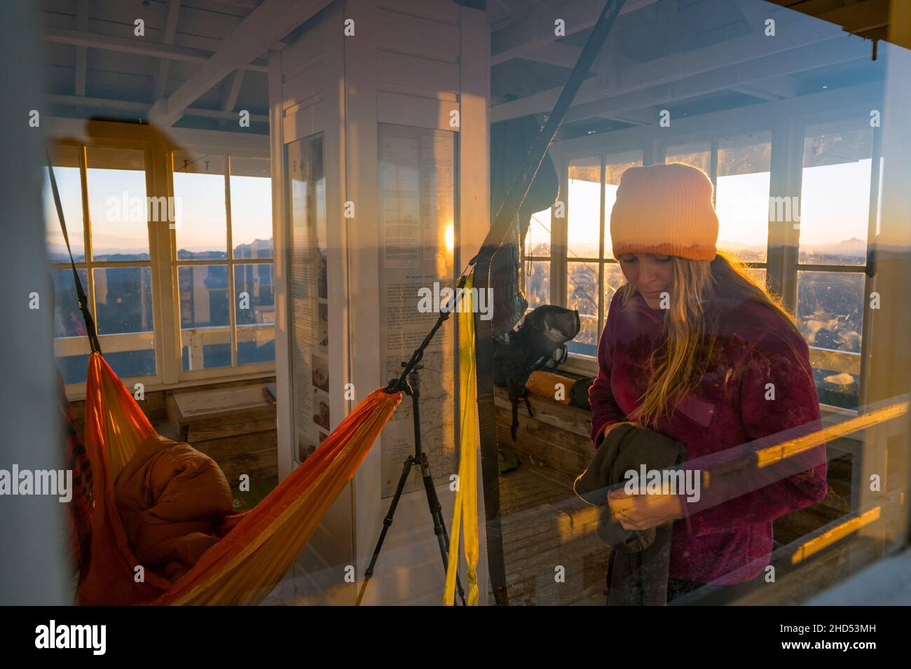 A female seen through the glass window of a fire lookout Stock Photo ...