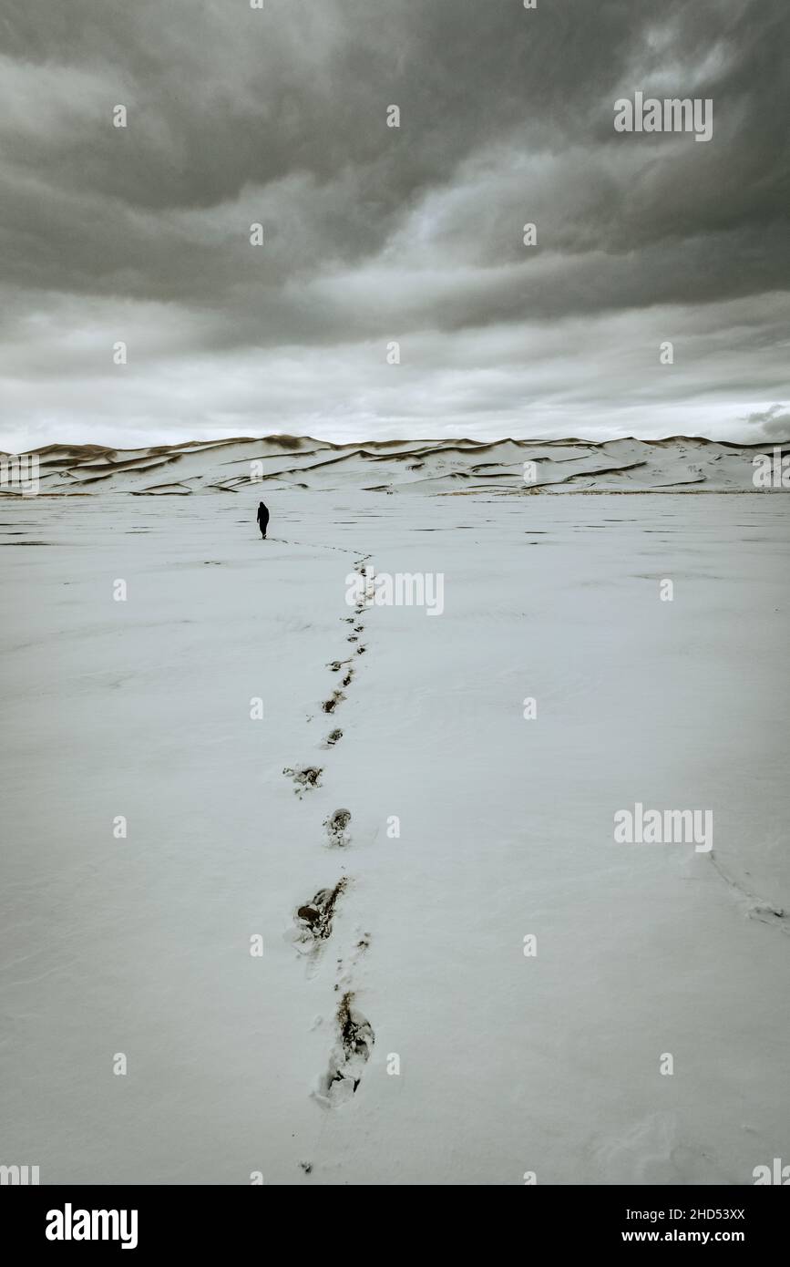 footsteps of person in snow recede distance, Great Sand Dunes Colorado ...