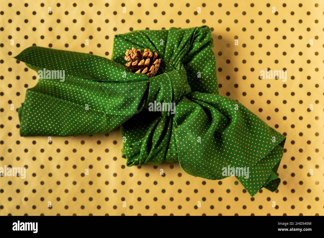 Fabric Wrapped Present on Gold Background Stock Photo - Alamy