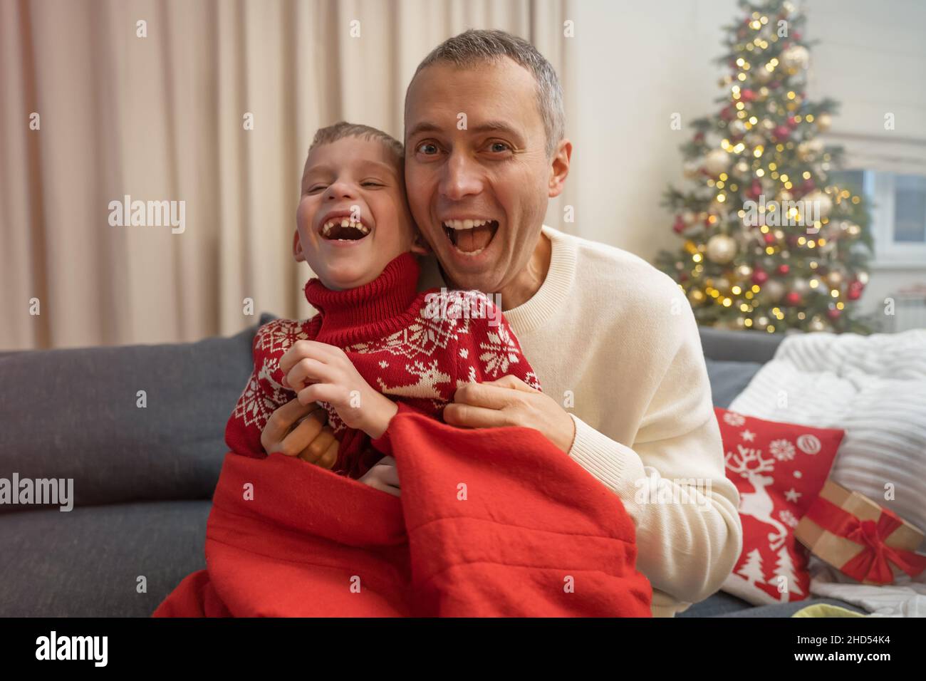 dad and son play and laugh with santa bag Stock Photo - Alamy