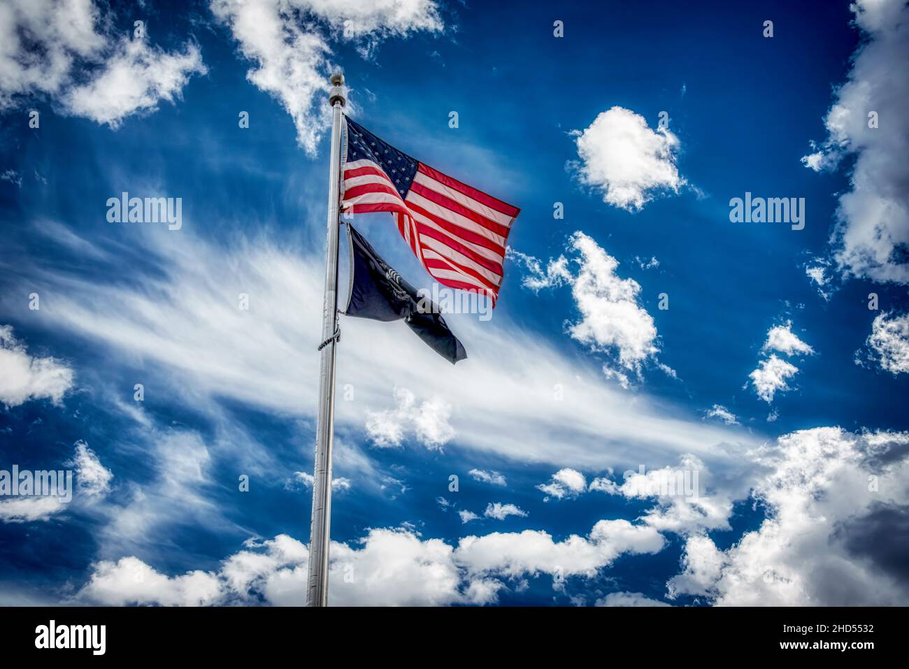 American flag standing tall against angry sky hi-res stock photography ...