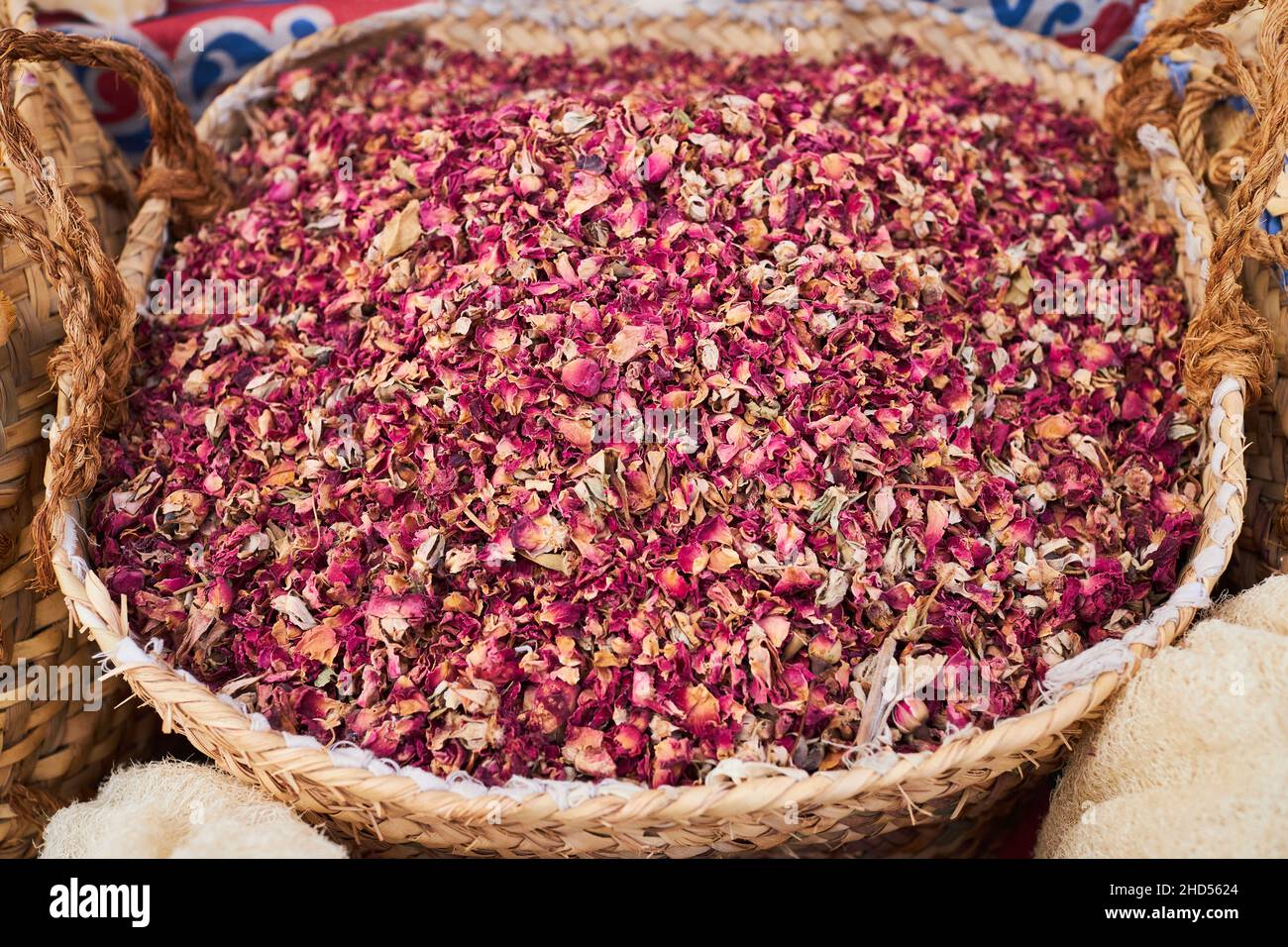 Dried pink rose flowers at the basket. Aromatic petals for tea at the ...