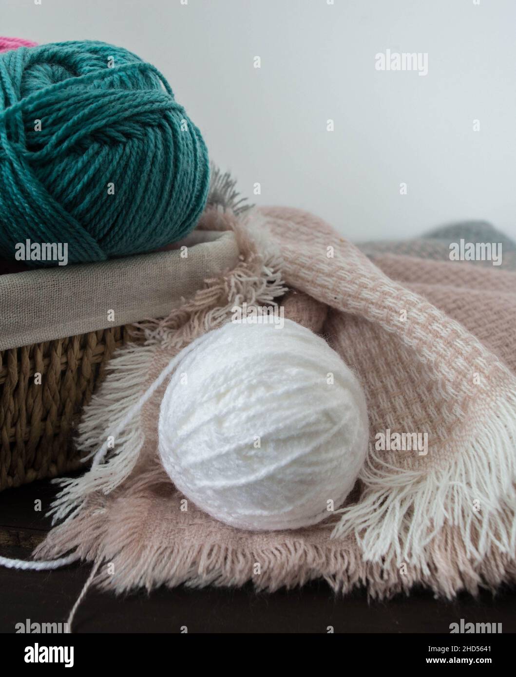 colorful woolen balls on dark brown wooden ground for handicrafts ...