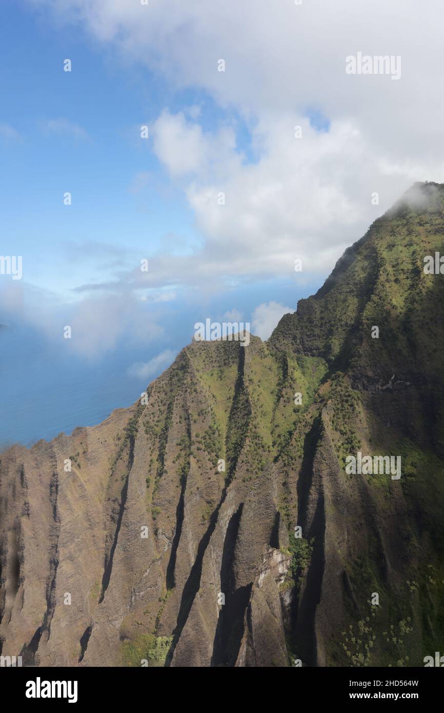 An aerial view of the sheer volcanic cliffs of the Napili Coast covered ...
