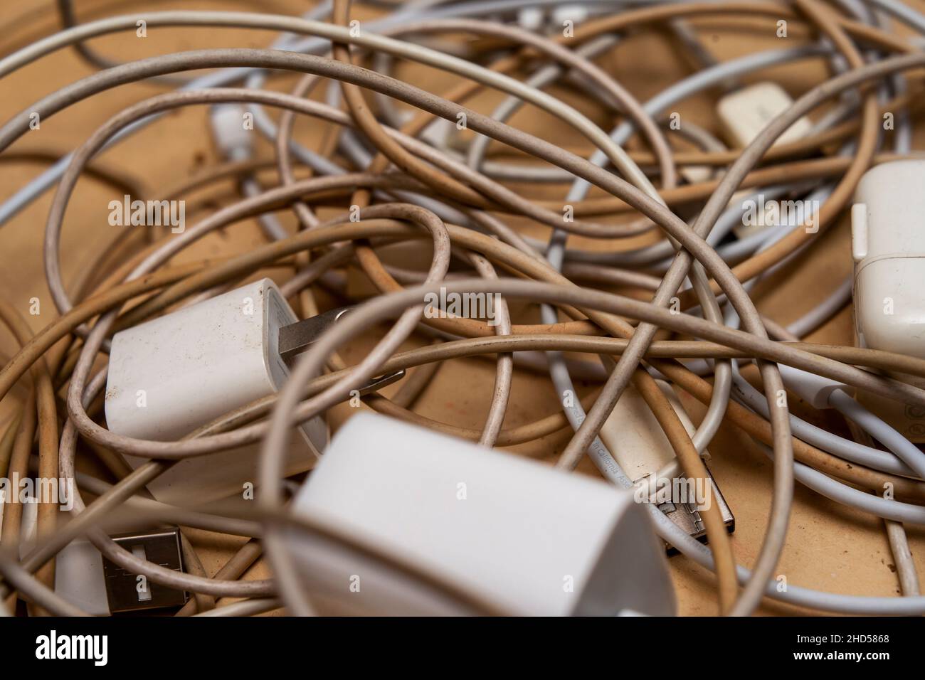 A ÒratÕs nestÓ of various power cords for Apple Computer products in a ...