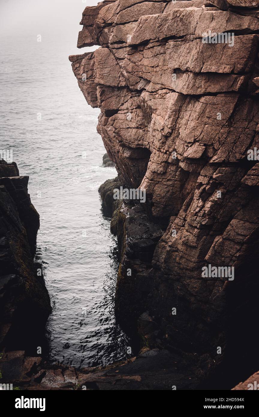 Rising tide waves crashing into a natural rock inlet called Thunder ...