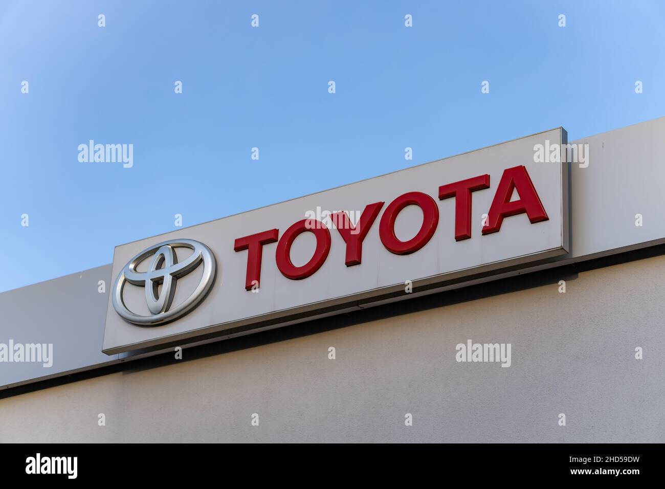 Close-up shot of a Toyota car dealer logo sign on a building in the ...