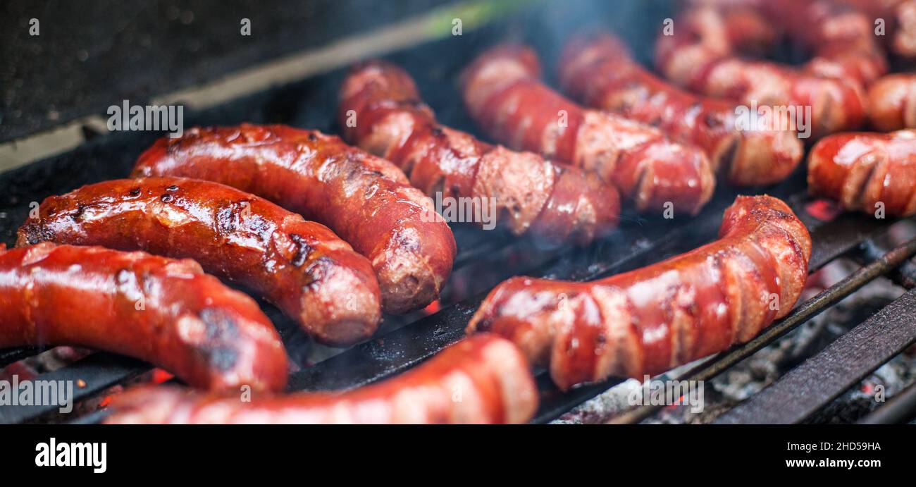 Grilling sausages on barbecue grill. Selective focus Stock Photo - Alamy