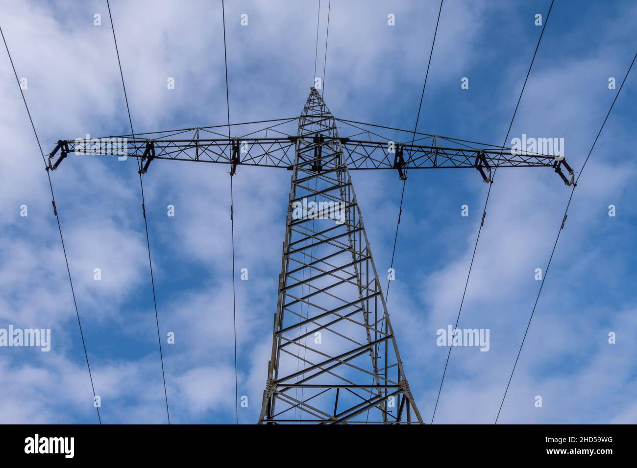 Low-angle shot of an electrical tower on a cloudy sky Stock Photo - Alamy