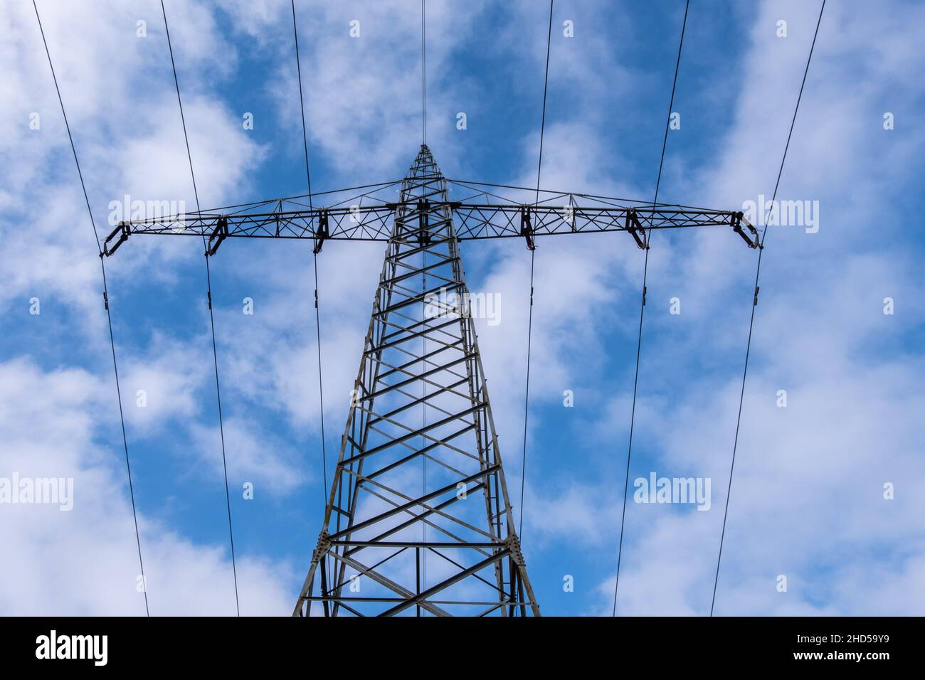 Low-angle shot of an electrical tower on a cloudy sky Stock Photo - Alamy