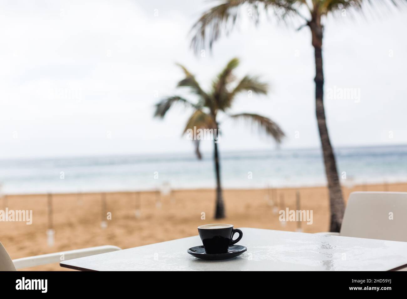a cup of coffee on the beach and palm tree Stock Photo - Alamy