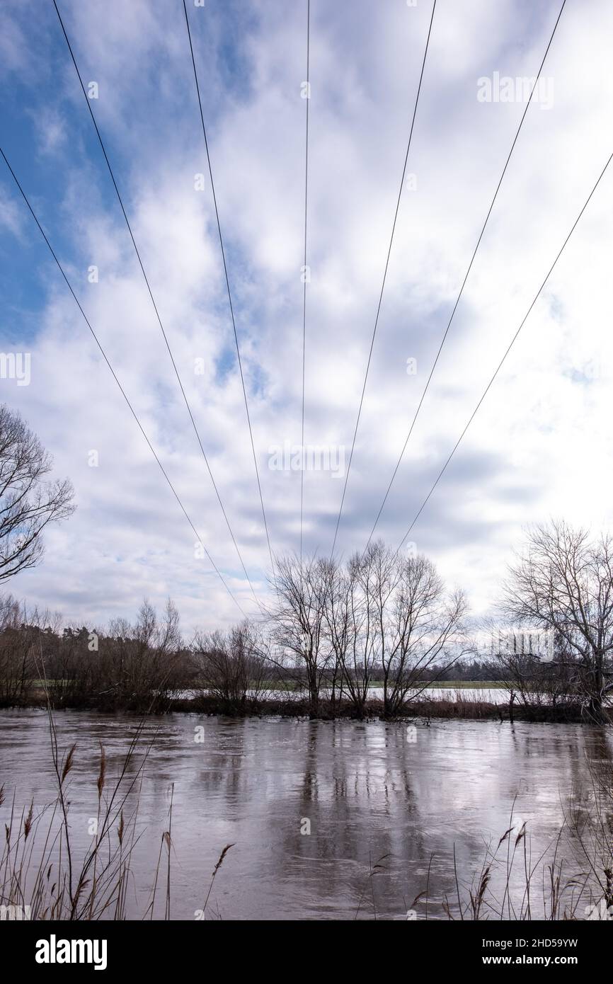 Tranquil scenery of electrical wires reflecting on the pond in the ...