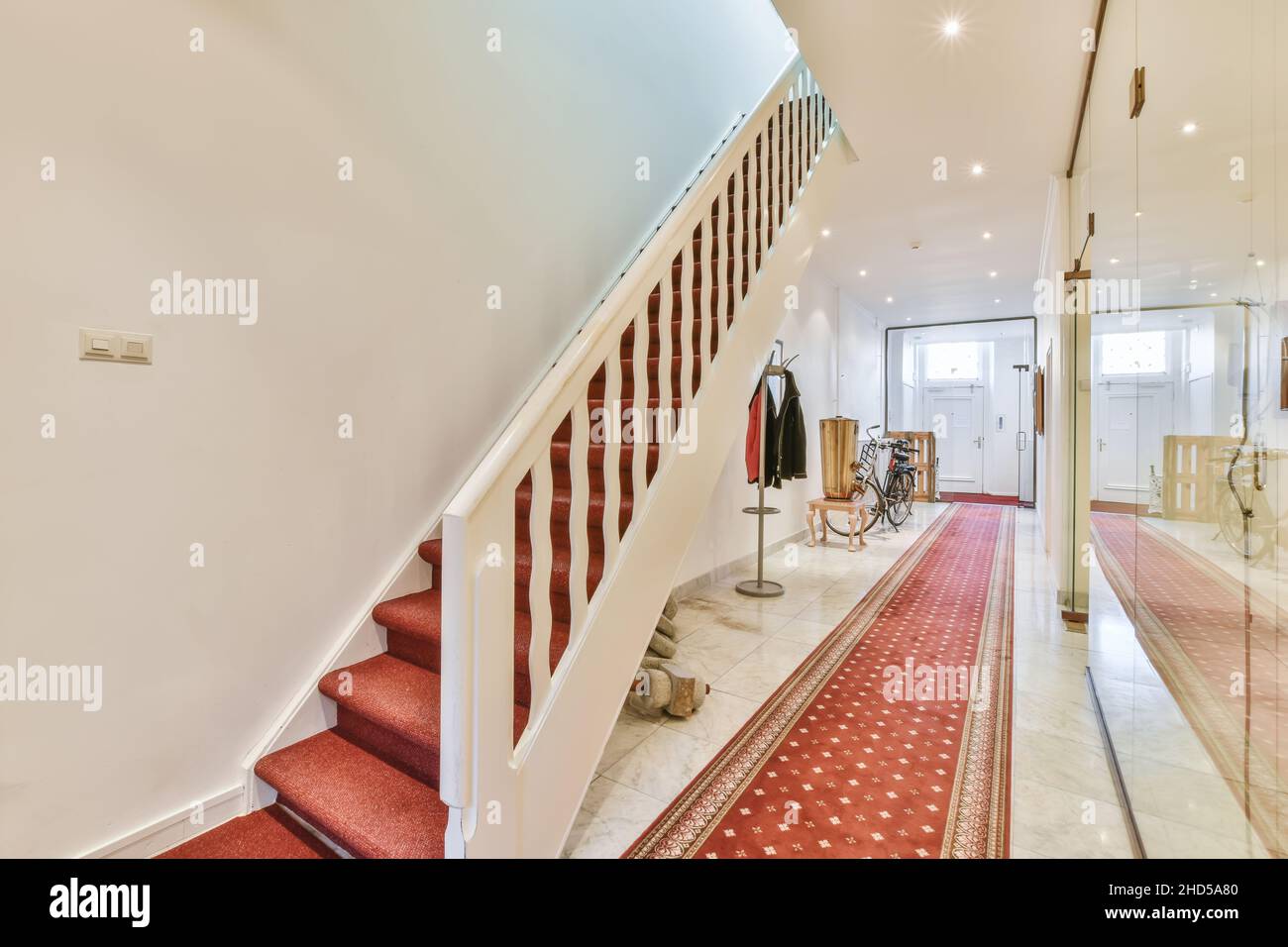 Spacious and long corridor with white walls and stunning tiles Stock ...