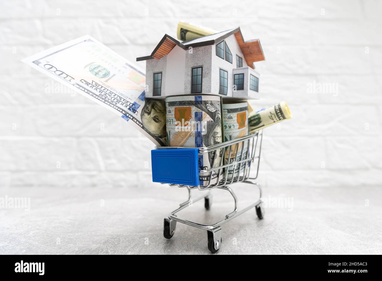 House and money in shopping cart, Buying and selling real estate ...