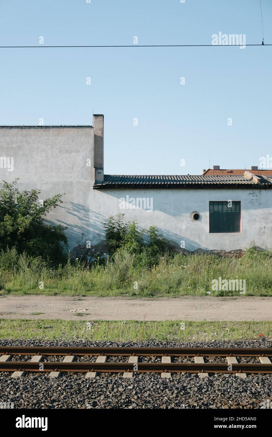 Vertical shot of a railroad and a building Stock Photo - Alamy