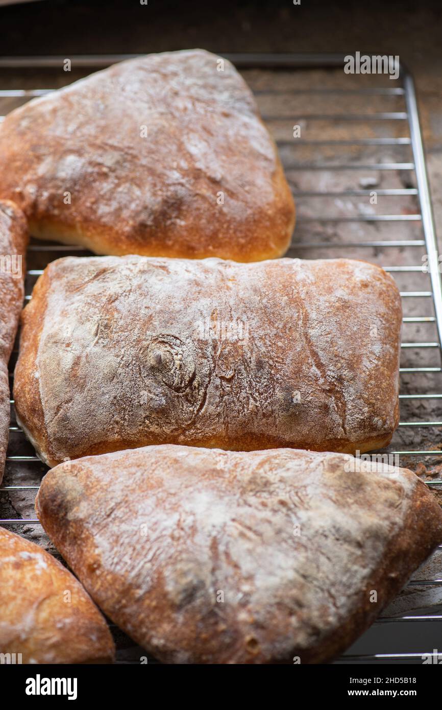Batch of ciabatta bread on a cooling rack. Close up Stock Photo - Alamy
