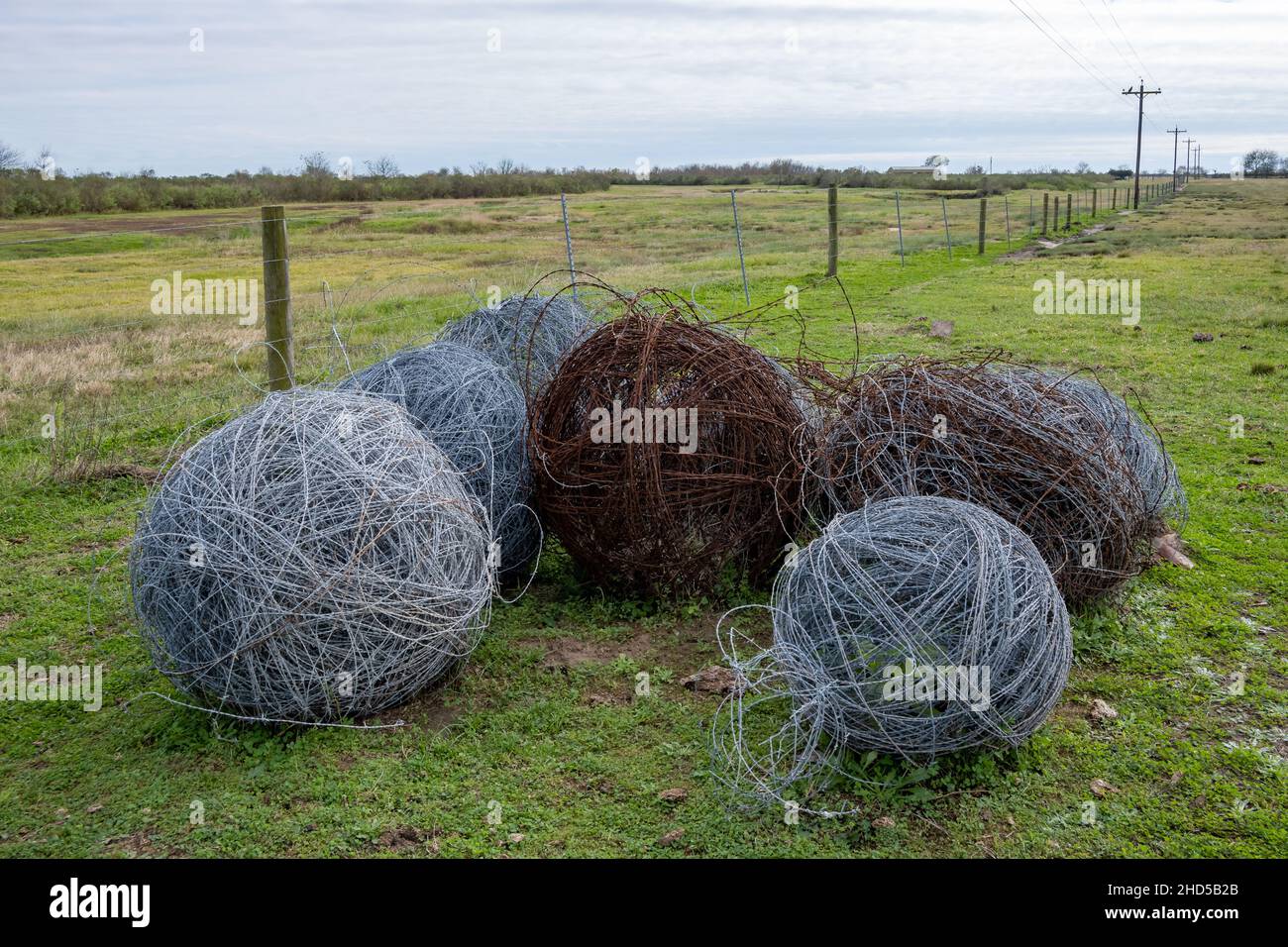 Huge balls of barb wires by the fence at a ranch. Matagorda, Texas, USA ...