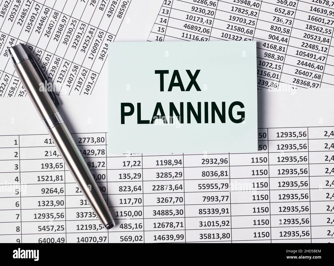 Tax planning text on paper over business documents Stock Photo - Alamy