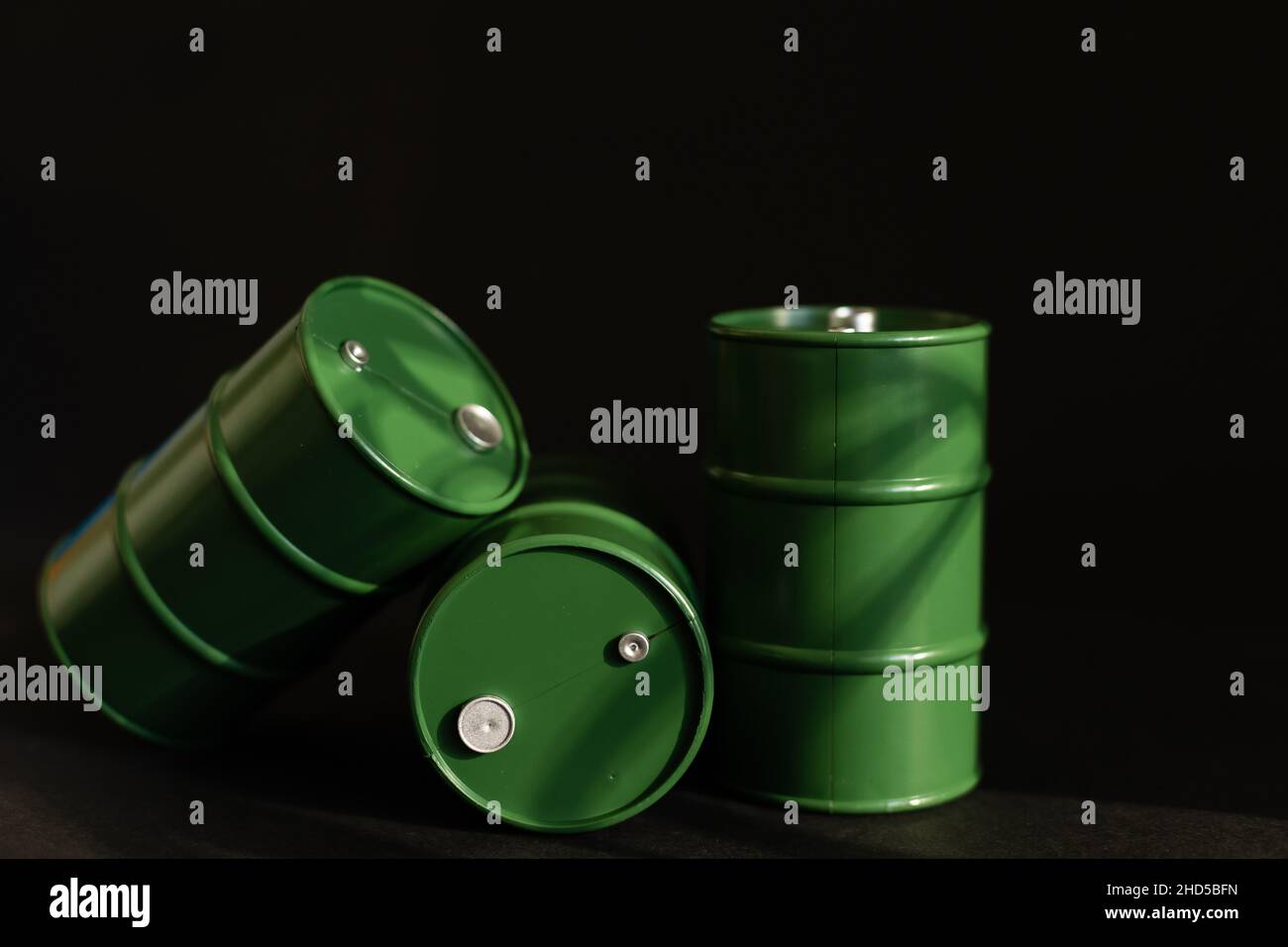 Threemetal barrels isolated close up, black background, oil drum, steel ...