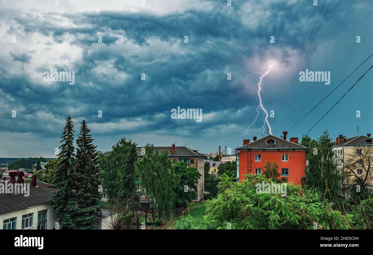 A loop-shaped lightning strikes a red multi-storey building during a ...
