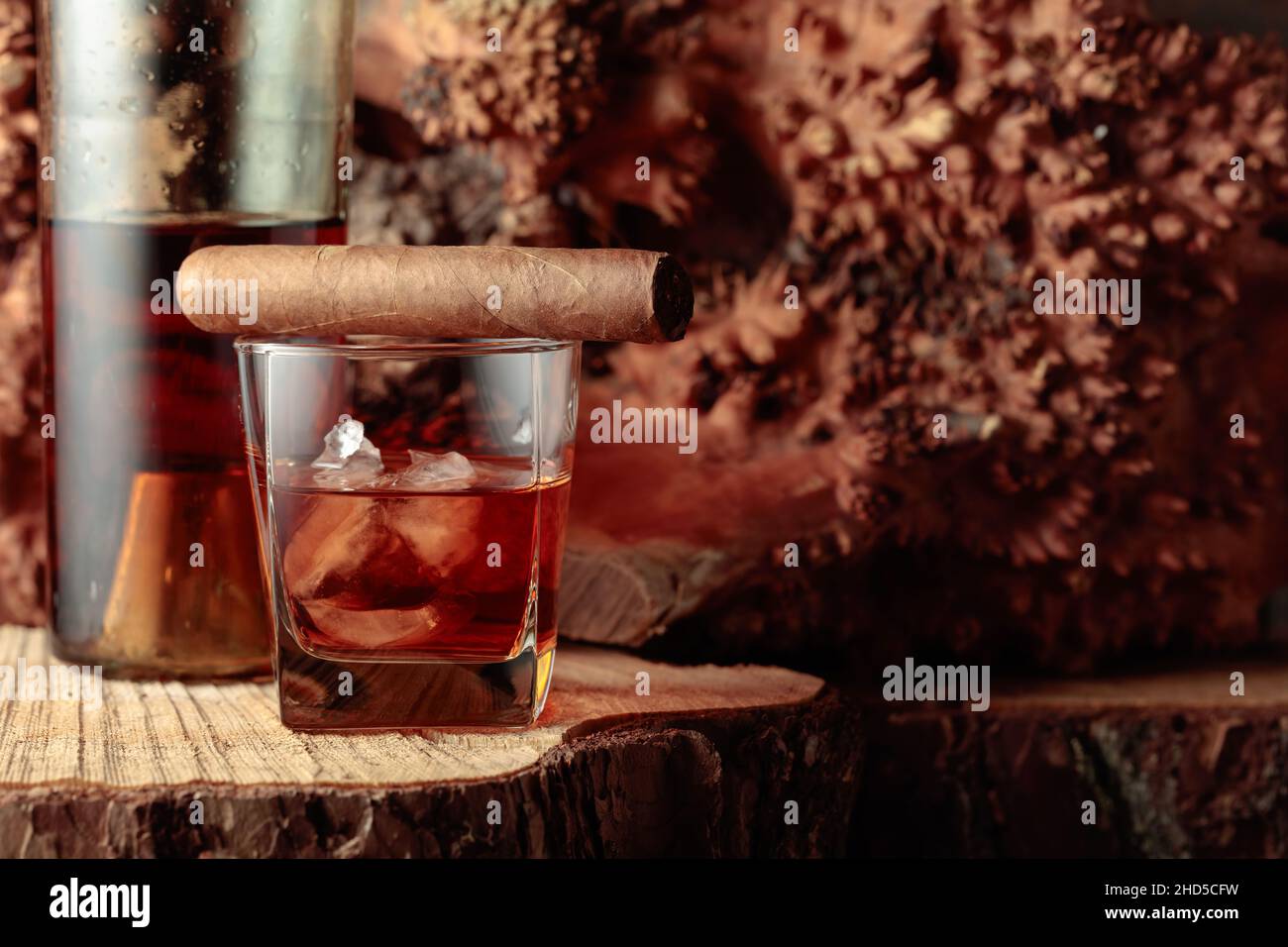 Whiskey wit ice and cigar on an old dried stump. Copy space Stock Photo ...