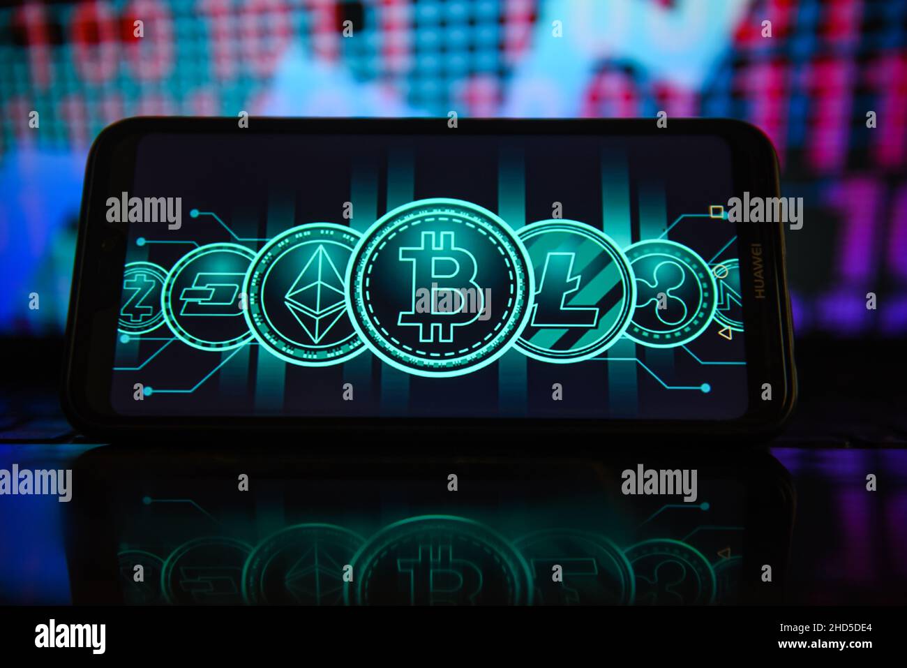 In this photo illustration Cryptocurrency logos seen displayed on a smartphone with stock market ...
