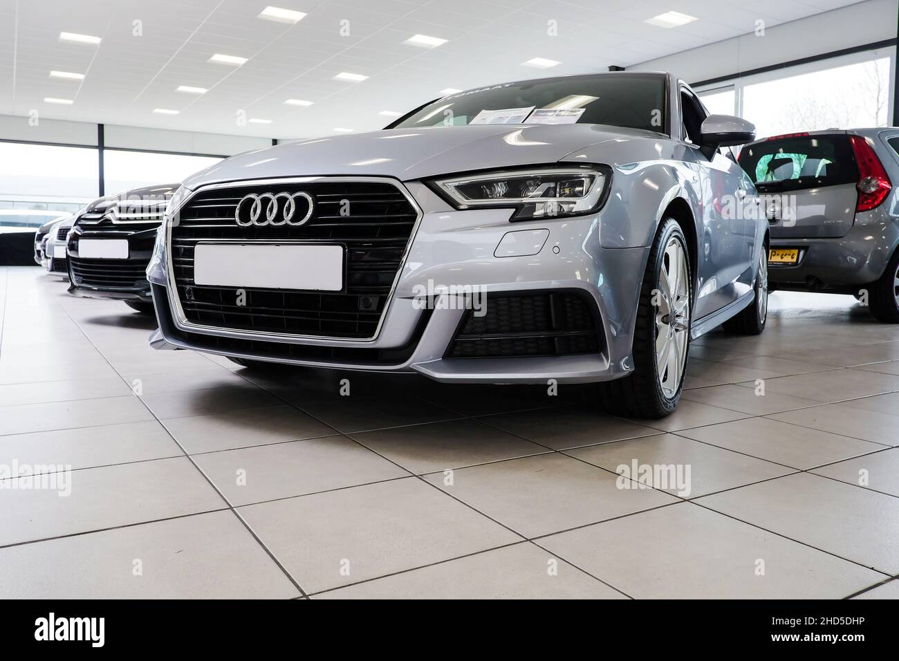Various brands and types of cars prepared for sale in a showroom Stock ...