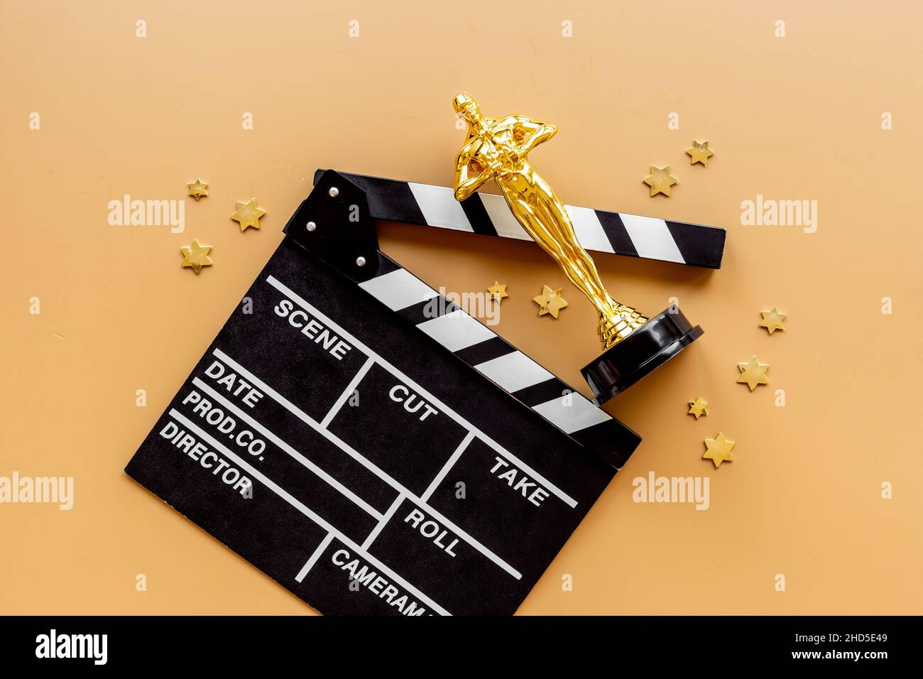 Movie clapper board with golden film award statue Stock Photo - Alamy