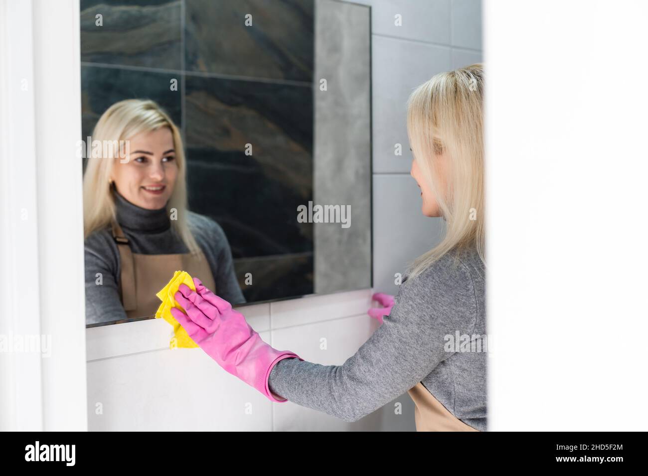 Woman wiping mirror housework hi-res stock photography and images - Alamy