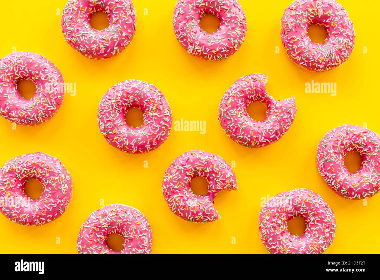 Set of pink glazed donutes with sprinkles, top view Stock Photo - Alamy