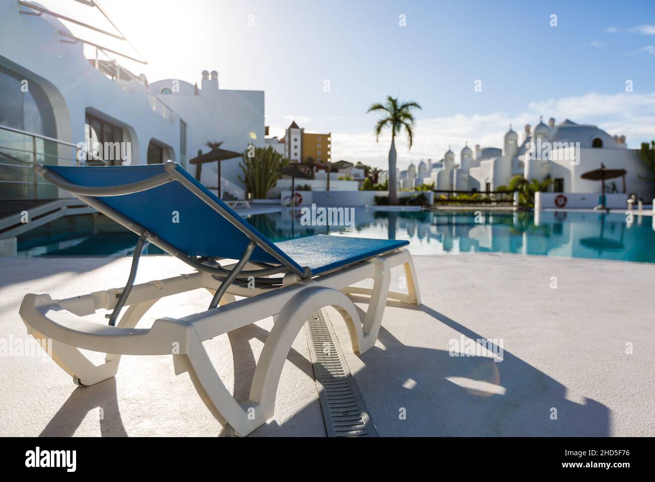 swimming pool with empty sun loungers Stock Photo - Alamy
