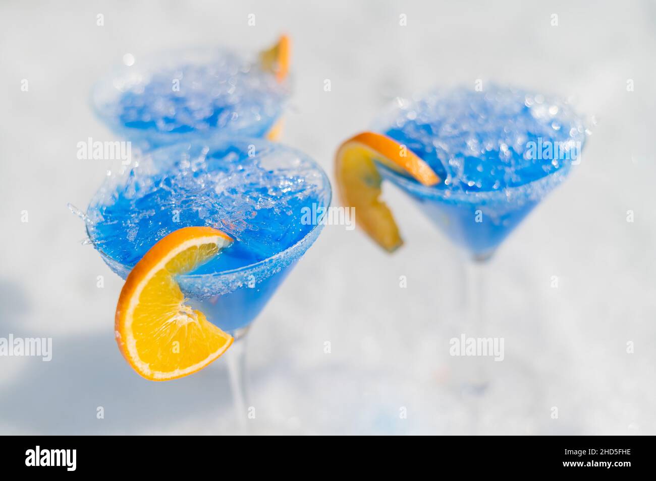 Three blue alcoholic cocktails on the snow Stock Photo - Alamy