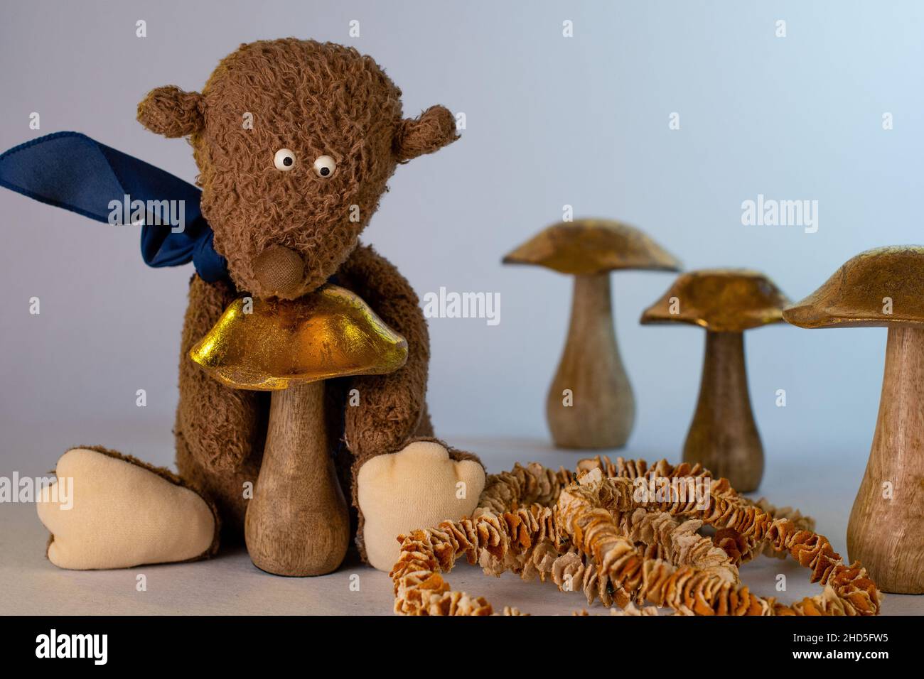 Teddy Teddybear with golden wooden mushrooms Stock Photo - Alamy