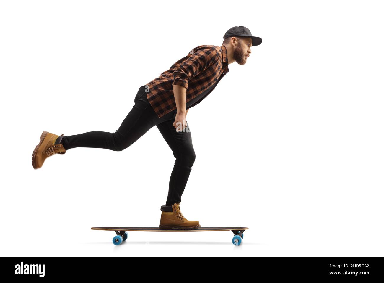 Full length profile shot of a trendy guy riding a longboard isolated on ...