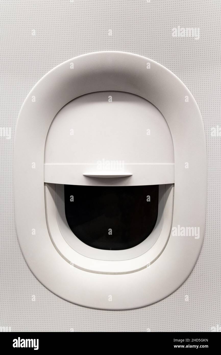 Half closed airplane window shade Stock Photo - Alamy