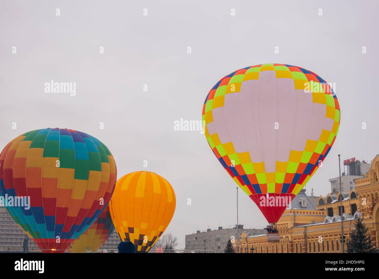 Colorful hot air balloons rising up against historical building Stock ...