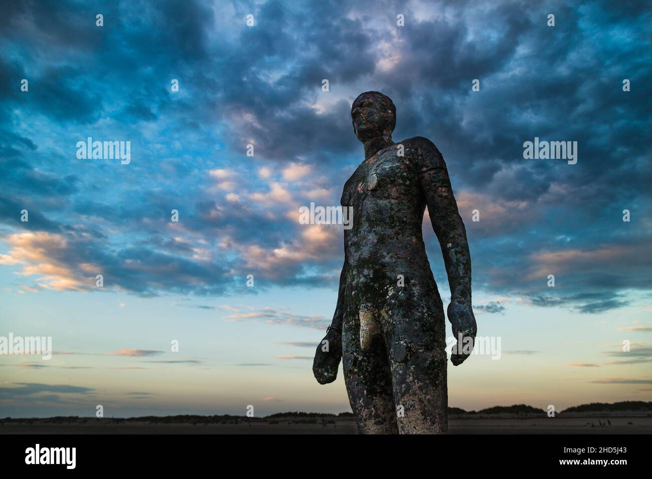 An Iron Man on Crosby beach near Liverpool towers above the beach as he ...