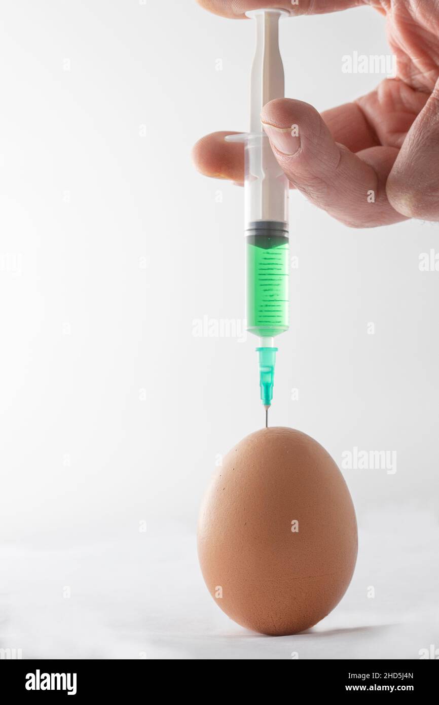 injecting an egg with green toxic substance Stock Photo - Alamy