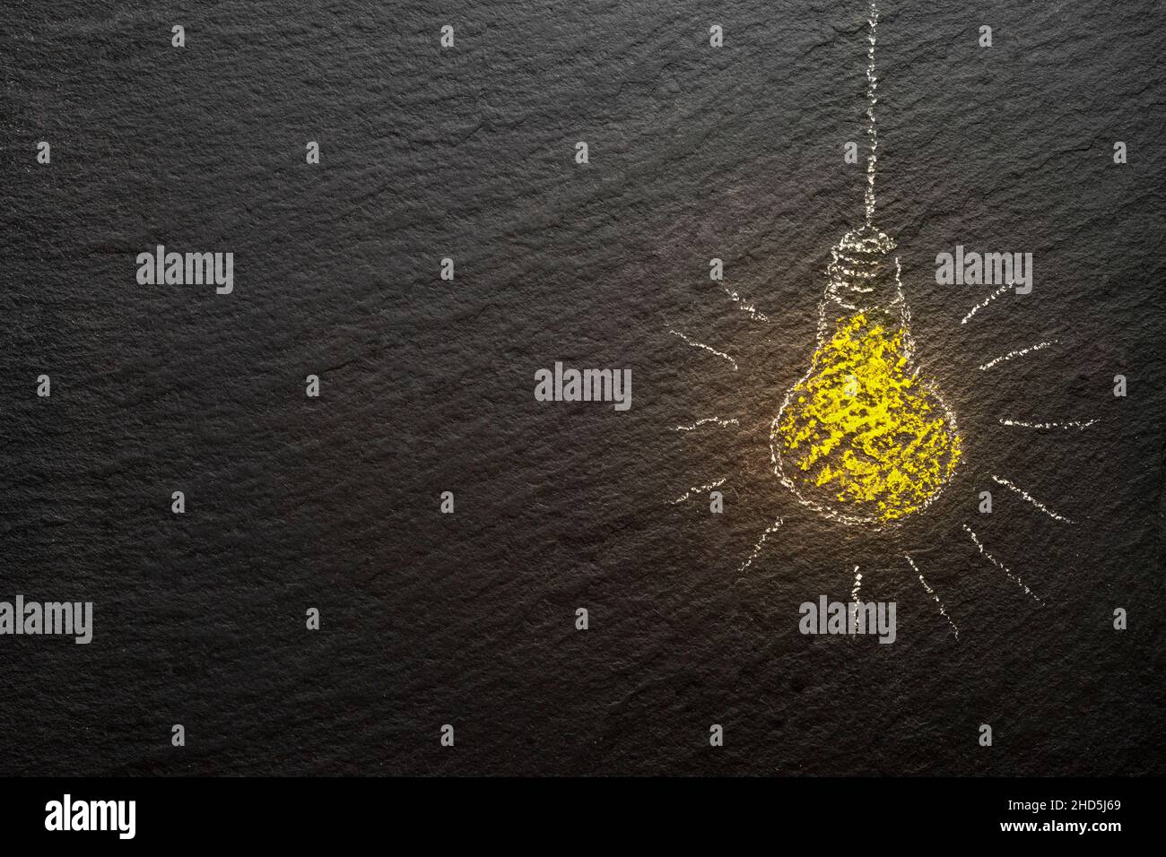 chalk light bulb glowing, sketch on black stone tile texture Stock ...