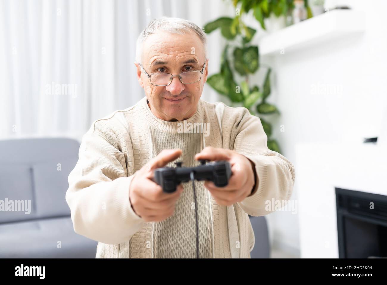 Senior man playing video game on white background Stock Photo - Alamy